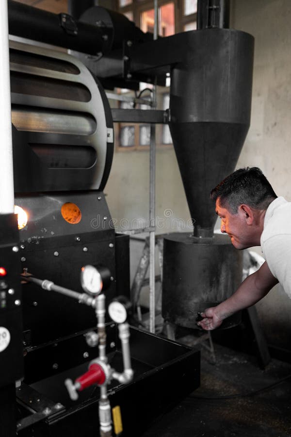 An Hispanic Man is Checking the Burner of a Coffee Roaster Machine ...