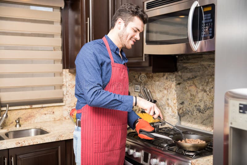 Hispanic Man Cooking at Home Stock Image - Image of latin, apron: 113381987