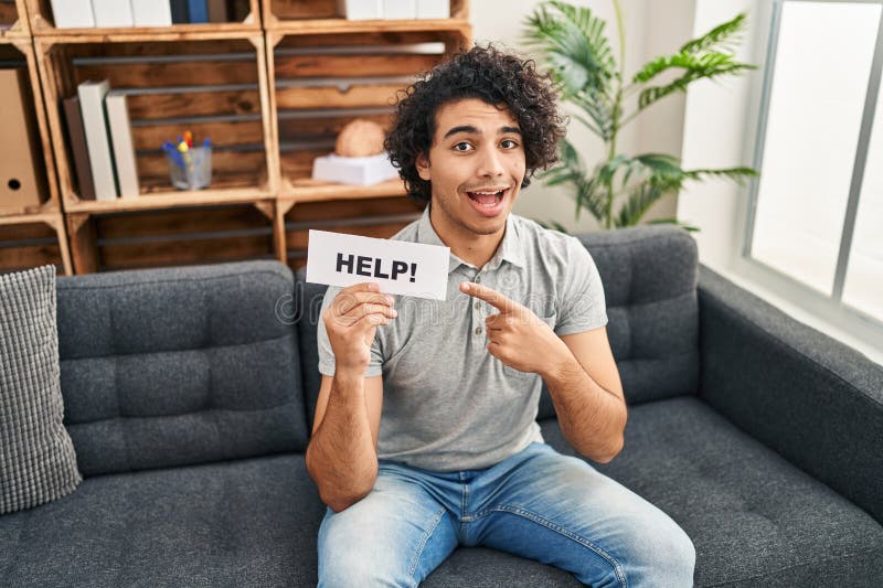 Hispanic Man with Curly Hair Asking for Help Smiling Happy Pointing ...