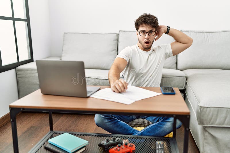 Hispanic Man Doing Papers at Home Crazy and Scared with Hands on Head ...