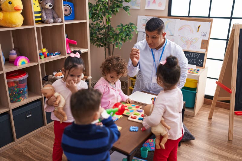 Hispanic Man and Group of Kids Having Lesson at Kindergarten Stock ...