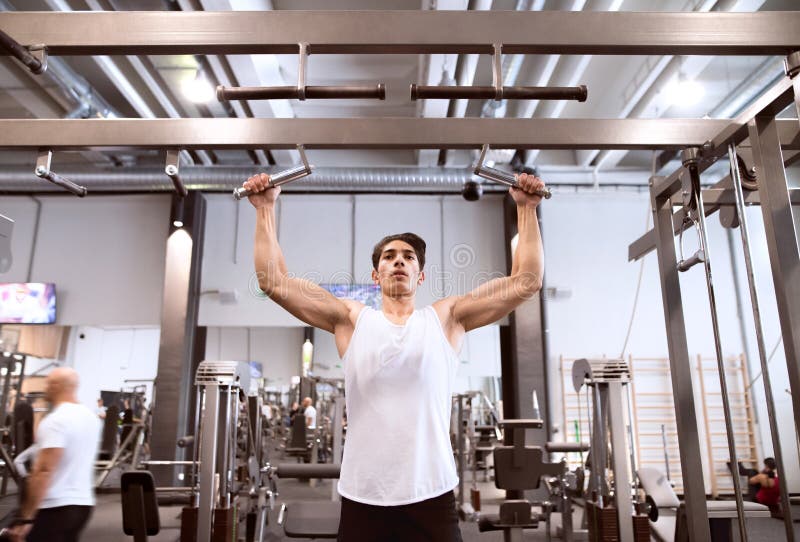 Hispanic Man in Gym Doing Pull-ups on Horizontal Bar Stock Image ...