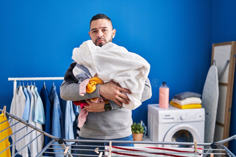 Hispanic Man Hanging Clothes at Clothesline Depressed and Worry for ...
