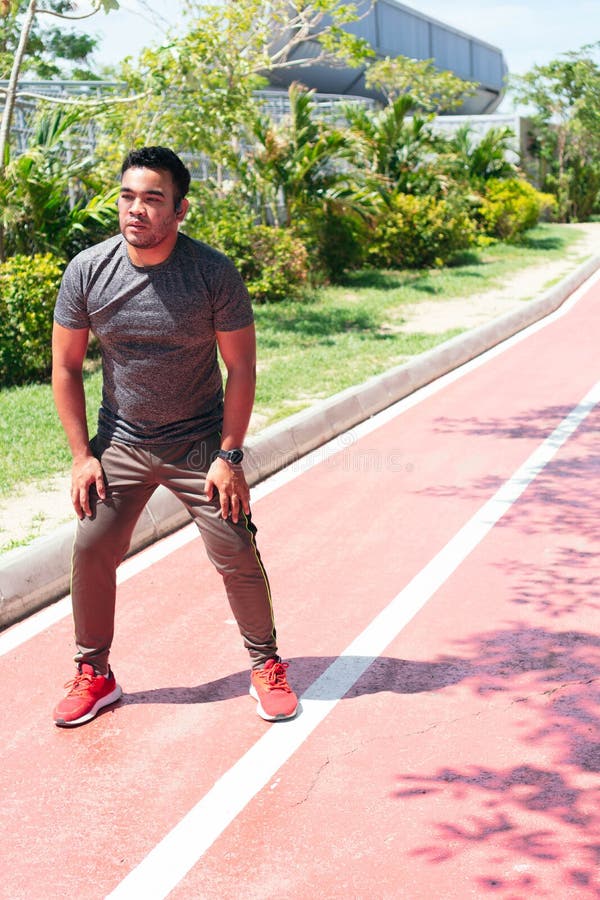 Hispanic Man Preparing To Run in the City Stock Image - Image of city ...