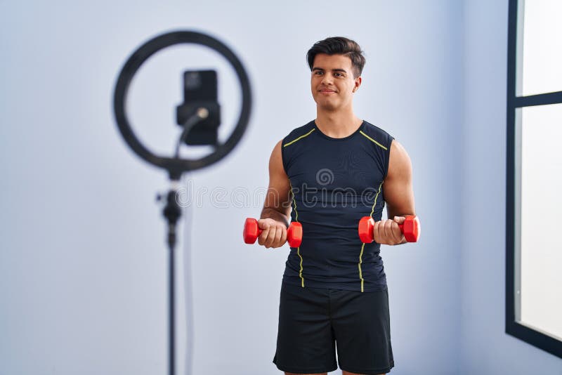 Hispanic Man Recording Training Tutorial at the Gym Relaxed with ...