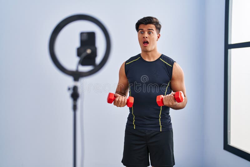 Hispanic Man Recording Training Tutorial at the Gym in Shock Face ...