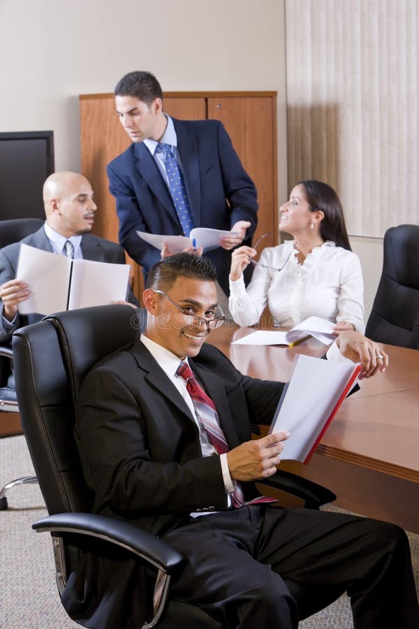 Hispanic Man with Report, Colleagues Conversing Stock Photo - Image of ...
