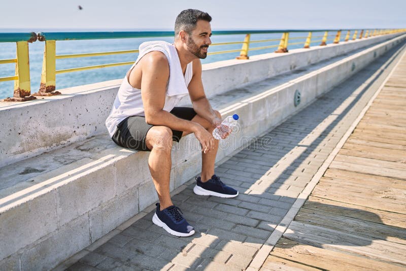 Hispanic Man Resting Sitting on a Bench after Working Out Outdoors on a ...
