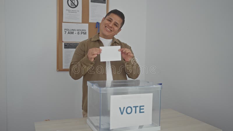 Hispanic Man Smiling while Casting a Ballot at a Voting Booth Indoors ...