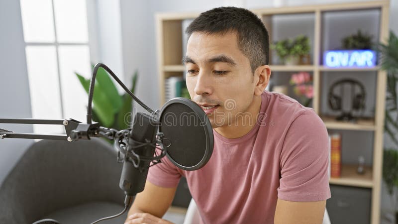 Hispanic Man Speaking into Microphone in Radio Studio Stock Photo ...
