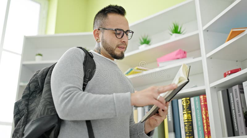 Hispanic Man Standing Reading Book at Library University Stock Photo ...