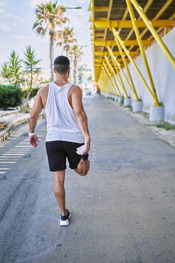 Hispanic Man Stretching after Working Out Outdoors on a Sunny Day Stock ...