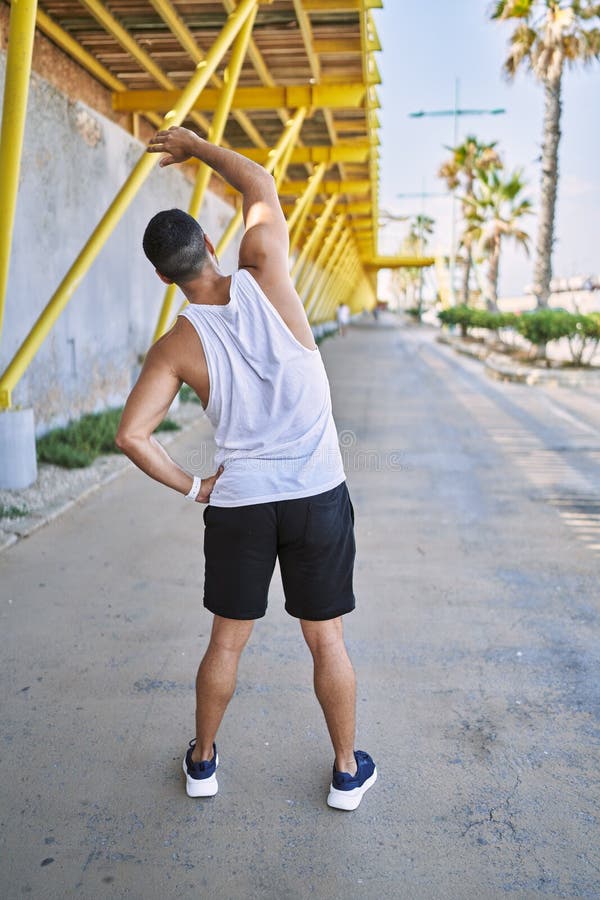 Hispanic Man Stretching after Working Out Outdoors on a Sunny Day Stock ...