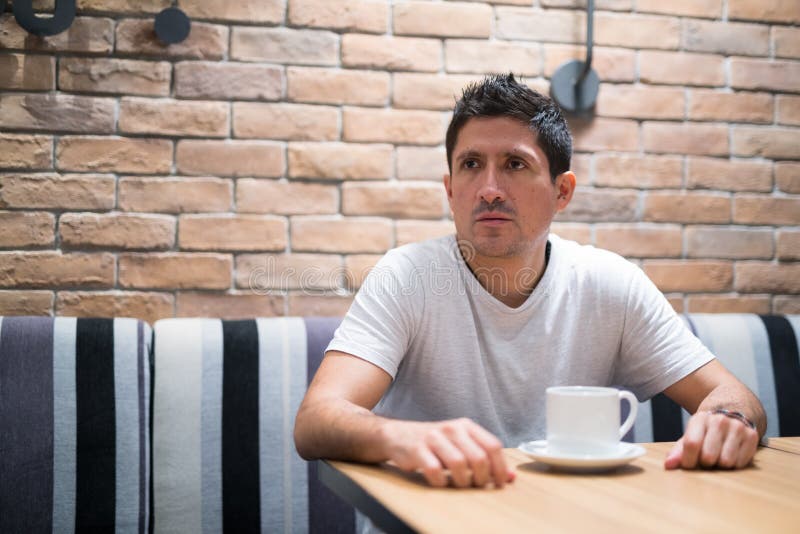 Hispanic Man Thinking while Relaxing at the Coffee Shop Stock Image ...