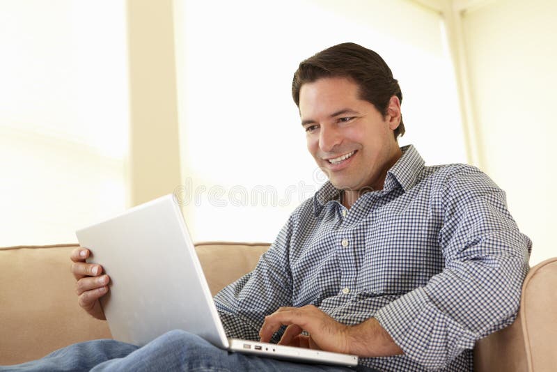 Hispanic Man Using Laptop at Home Stock Photo - Image of sitting ...