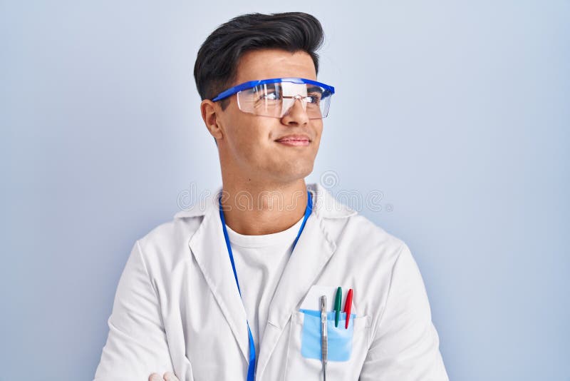 Hispanic Man Working As Scientist Smiling Looking To the Side and ...