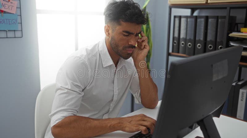 Hispanic Man Working on Computer in Office, Concentrating while Seated ...