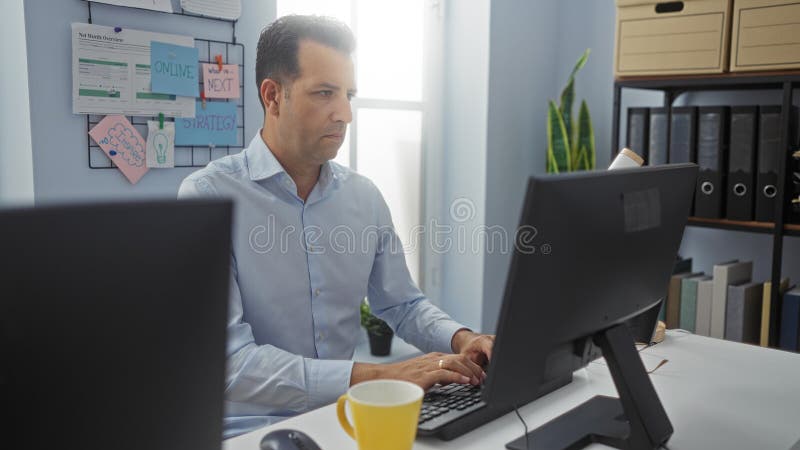 An Organized Office with Blue Numbered Cubicles, Desks, Monitors, and ...