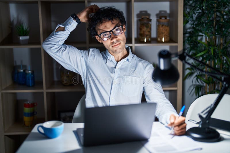 Hispanic Man Working at the Office at Night Confuse and Wondering about ...