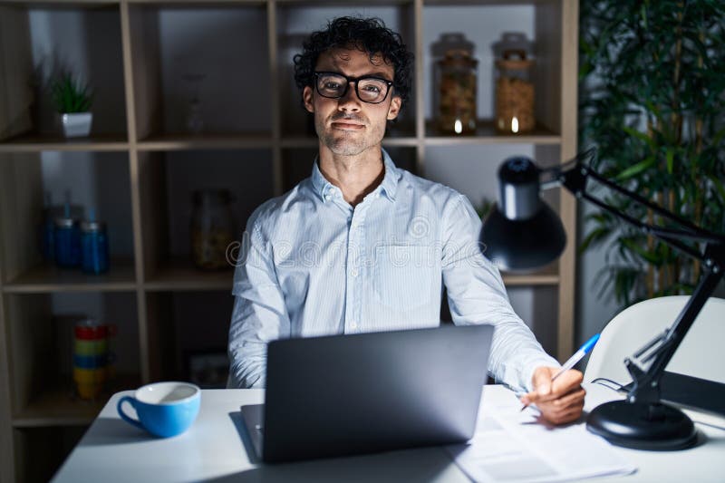Hispanic Man Working at the Office at Night Relaxed with Serious ...