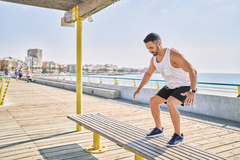 Hispanic Man Working Out Jumping a Bench Outdoors on a Sunny Day Stock ...