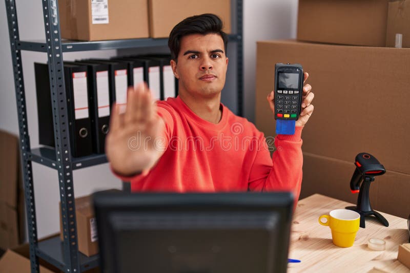 Hispanic Man Working at Small Business Ecommerce Holding Dataphone with ...