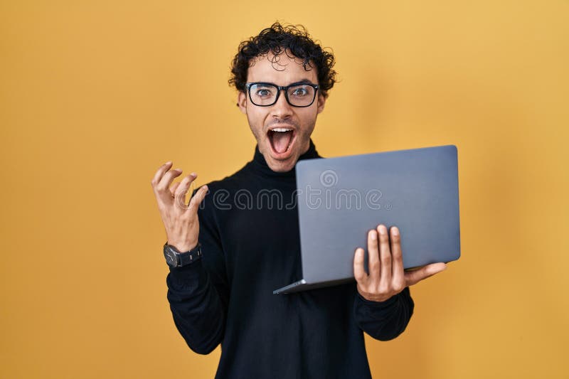 Hispanic Man Working Using Computer Laptop Celebrating Victory with ...