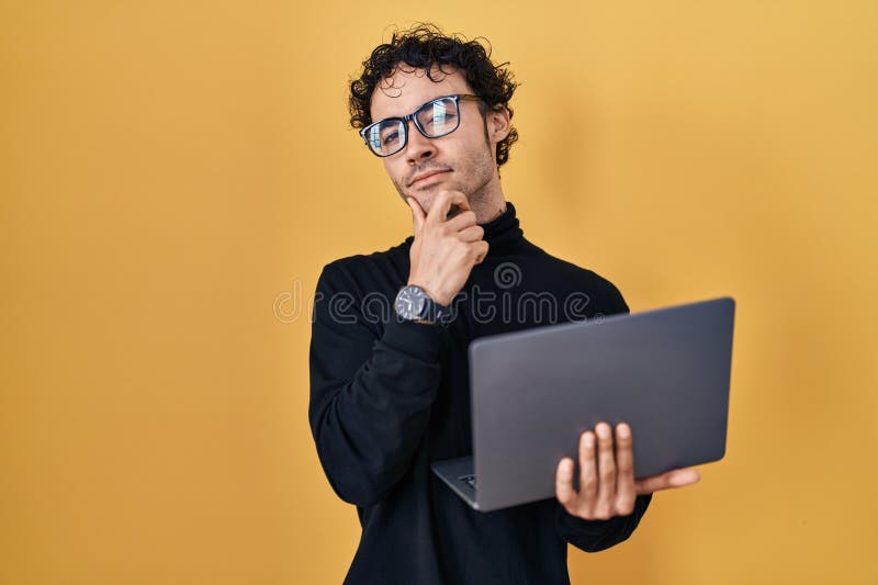 Hispanic Man Working Using Computer Laptop Serious Face Thinking about ...