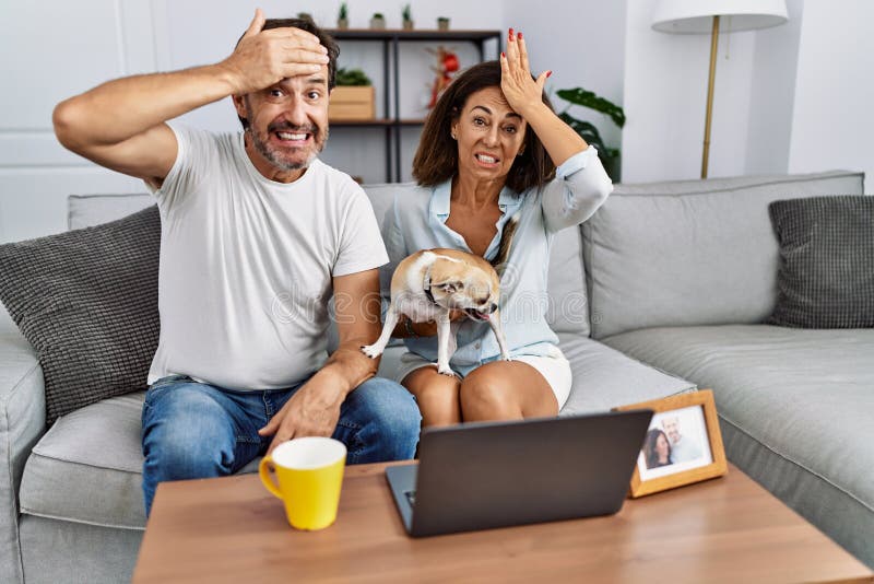 Hispanic Middle Age Couple Sitting on the Sofa Using Computer Laptop ...