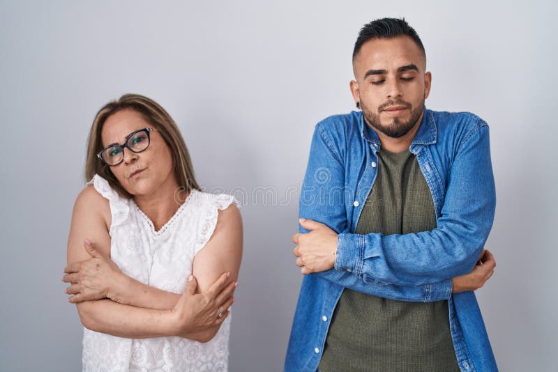 Hispanic Mother and Son Standing Together Shaking and Freezing for ...