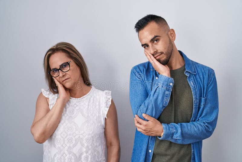 Hispanic Mother and Son Standing Together Thinking Looking Tired and ...