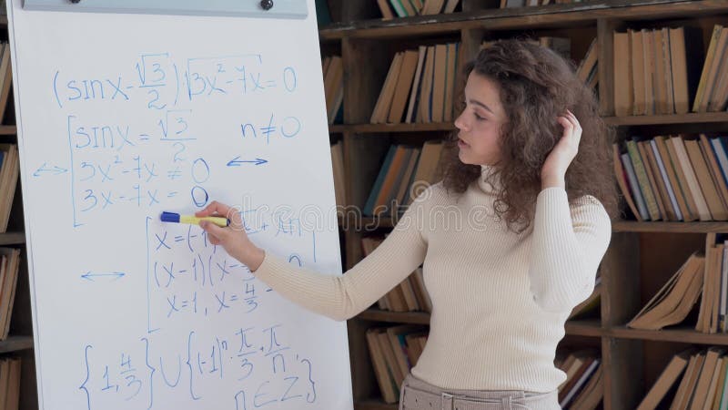 Hispanic School Teacher Giving Math Class Looking at Camera Explaining ...