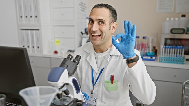 Hispanic Scientist Man in Lab Coat Gesturing Okay Sign with Microscope ...