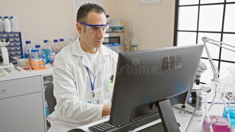 Hispanic Scientist Man in Lab Coat Working at Computer in Modern ...