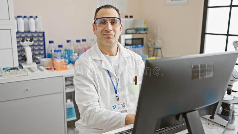Hispanic Scientist Man in Lab Coat Works with Computer in Laboratory ...