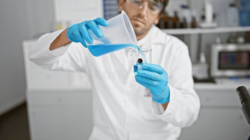 Hispanic Scientist Man Pouring Liquid with Care in Lab Stock Photo ...