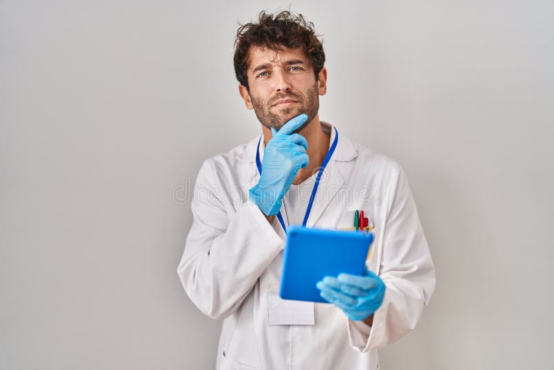 Hispanic Scientist Man Working with Tablet Serious Face Thinking about ...