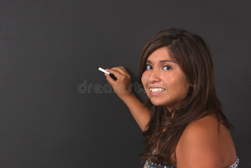 Hispanic Teenager Writing on a Blackboard Stock Photo - Image of ...