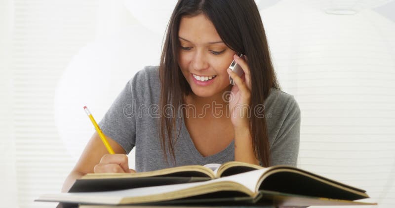 Hispanic Woman Calling Friend for Help with Homework Stock Photo ...