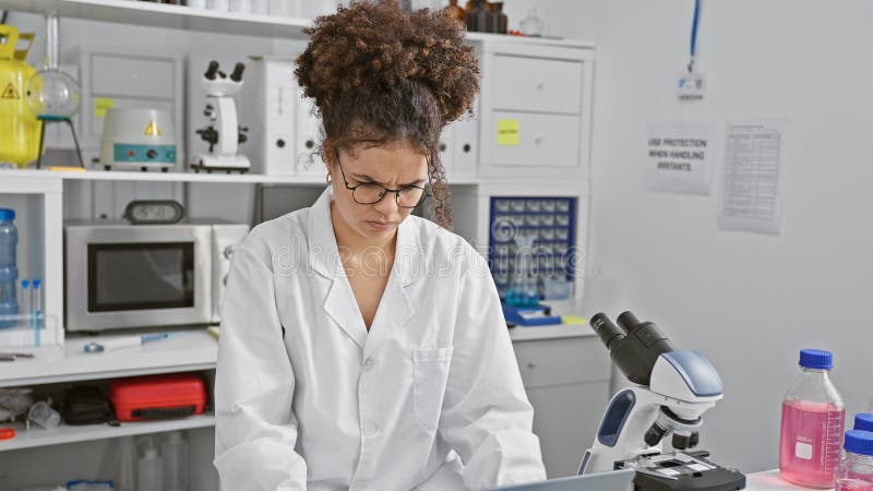 Hispanic Woman with Curly Hair Works in Laboratory, Analyzing Samples ...