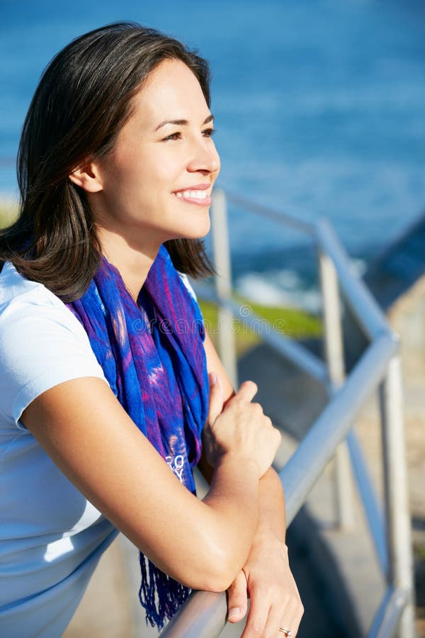 Hispanic Woman Looking Over Railing at Sea Stock Image - Image of happy ...