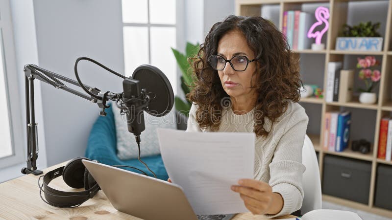 Hispanic Woman Reading Script in Radio Studio with Microphone and ...