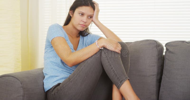 Hispanic Woman Sitting on Couch Thinking Stock Image - Image of casual ...