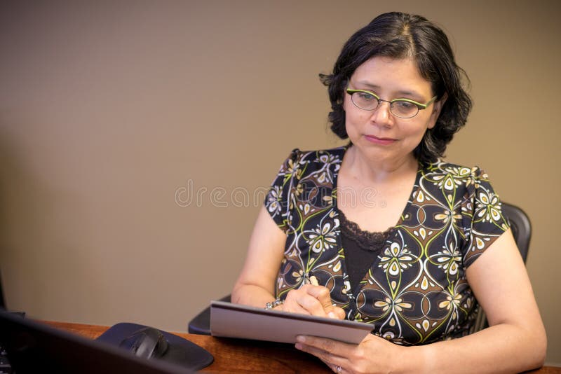 Hispanic Woman at Work Doing Desk Job Stock Image - Image of middle ...