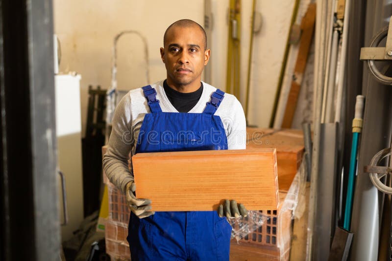Hispanic Worker Stacking Bricks in Warehouse of Building Materials ...