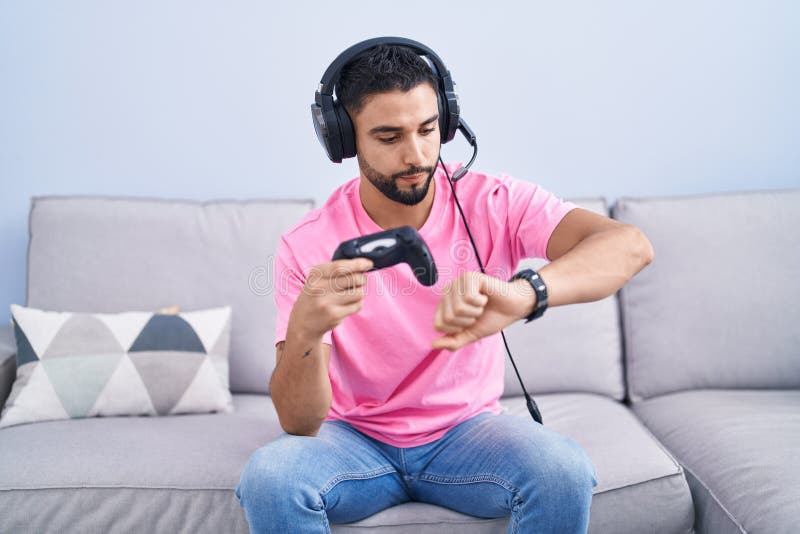 Hispanic Young Man Playing Video Game Holding Controller Sitting on the ...