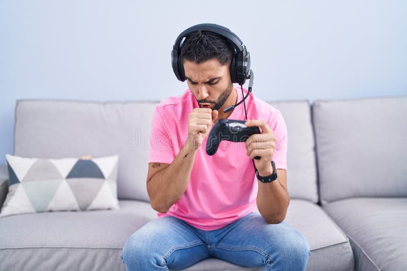 Hispanic Young Man Playing Video Game Holding Controller Sitting on the ...