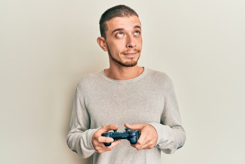 Hispanic Young Man Playing Video Game Holding Controller Smiling ...