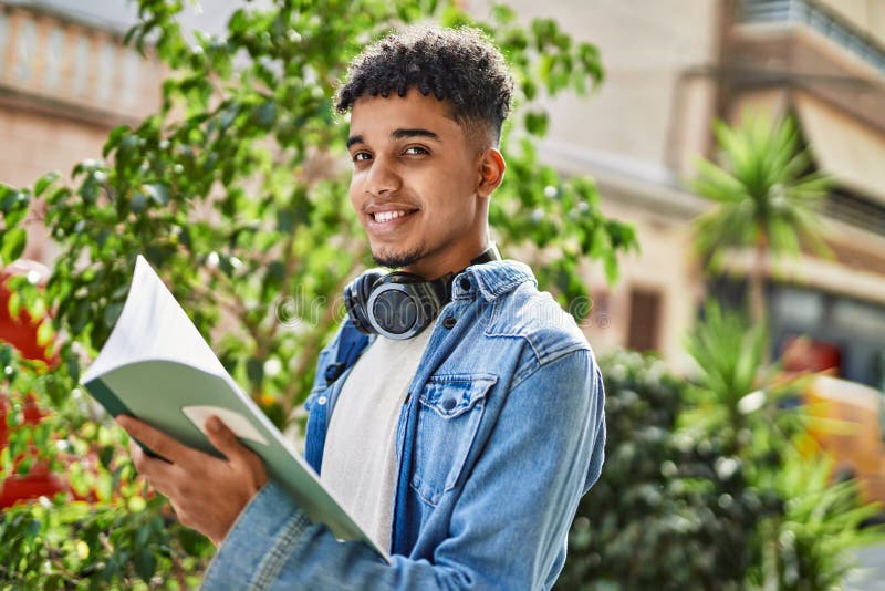 Hispanic Young Man Reading a Book at the Street Stock Image - Image of ...