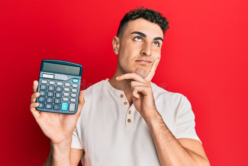 Hispanic Young Man Showing Calculator Device Serious Face Thinking ...